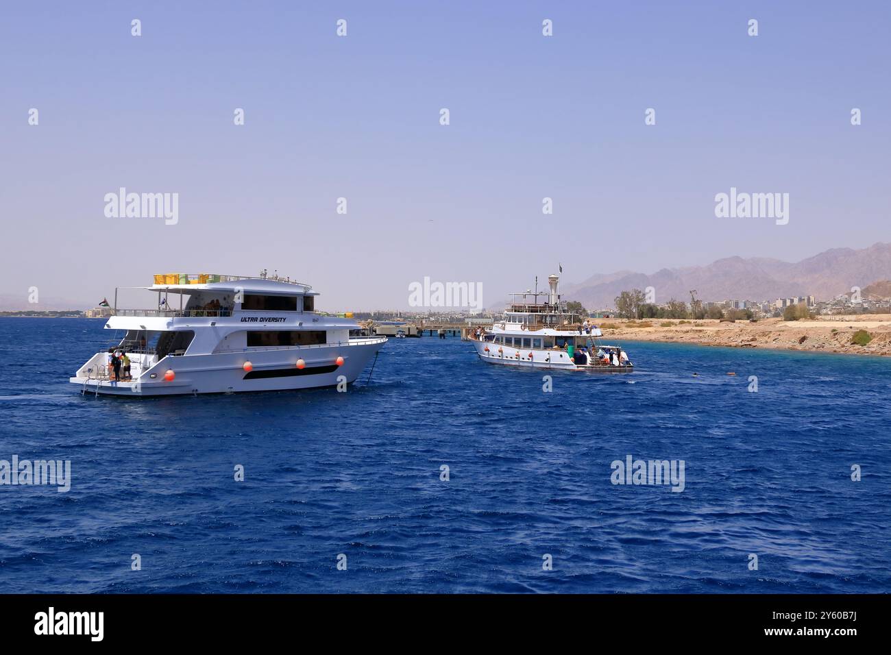 Aqaba in Jordan - May 17 2024: people enjoy a boat trip at the Gulf of ...