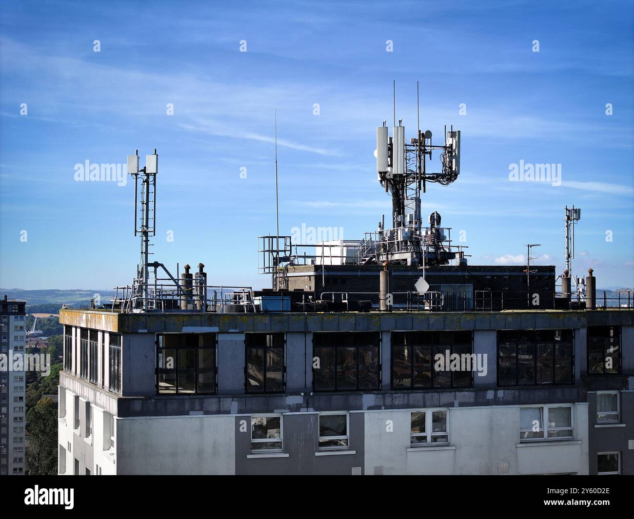 Aerial drone view of cellular phone masts on top of high rise tower ...