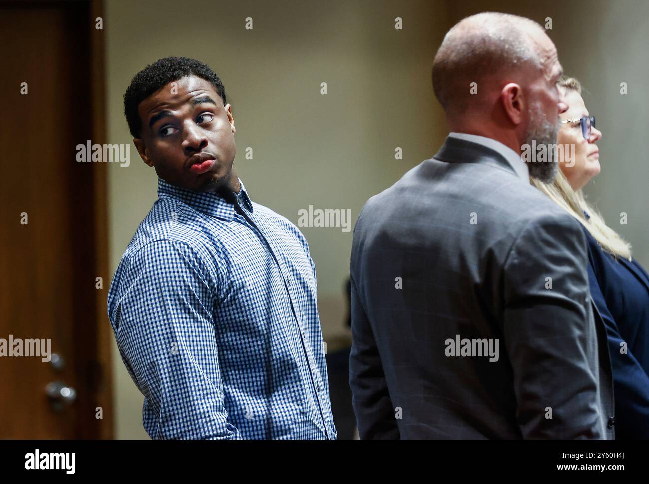 Defendant Justin Johnson, left, appears in court as the murder trial of ...