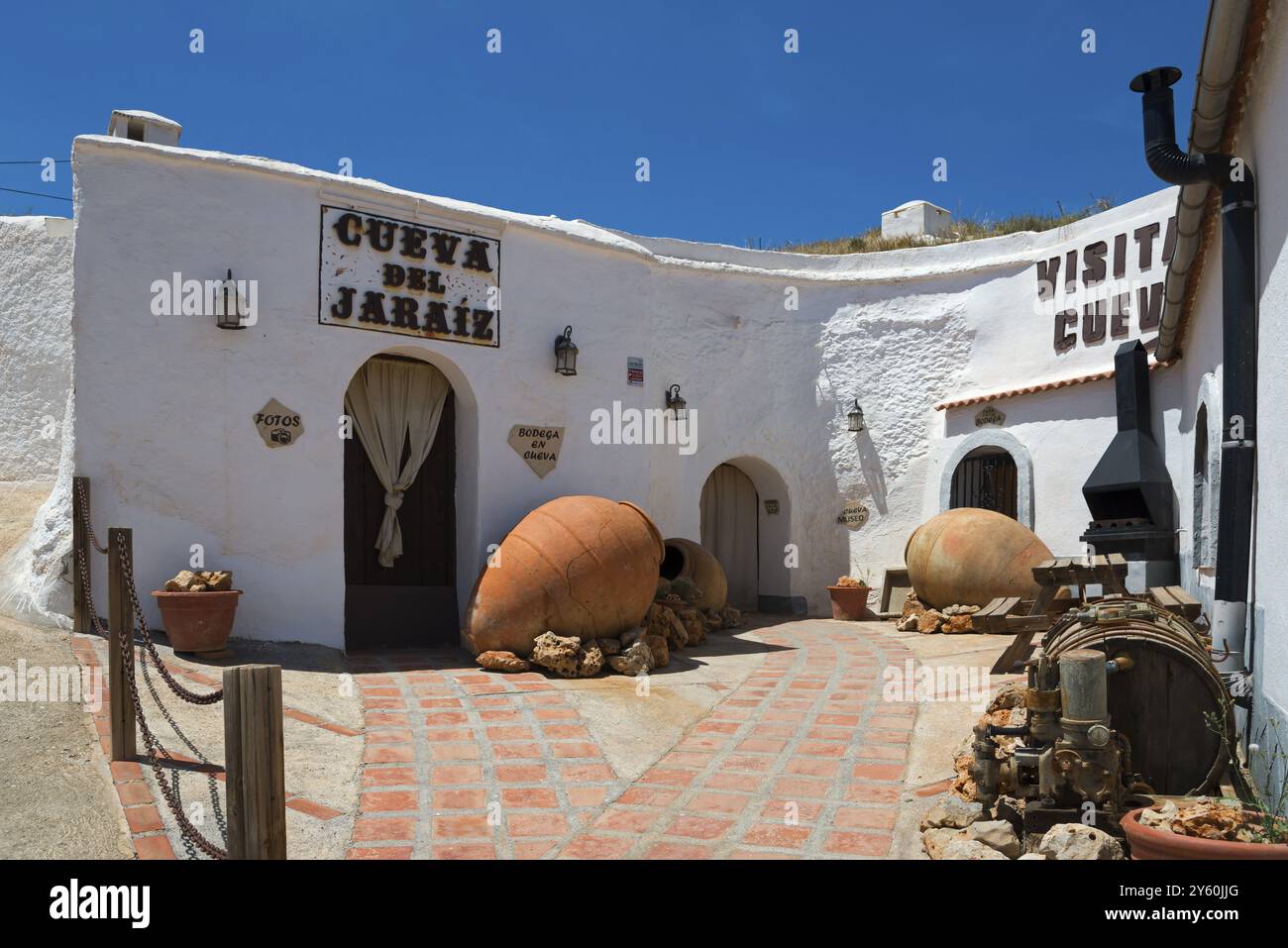 Rustic cave house with white walls and traditional decorations under a ...