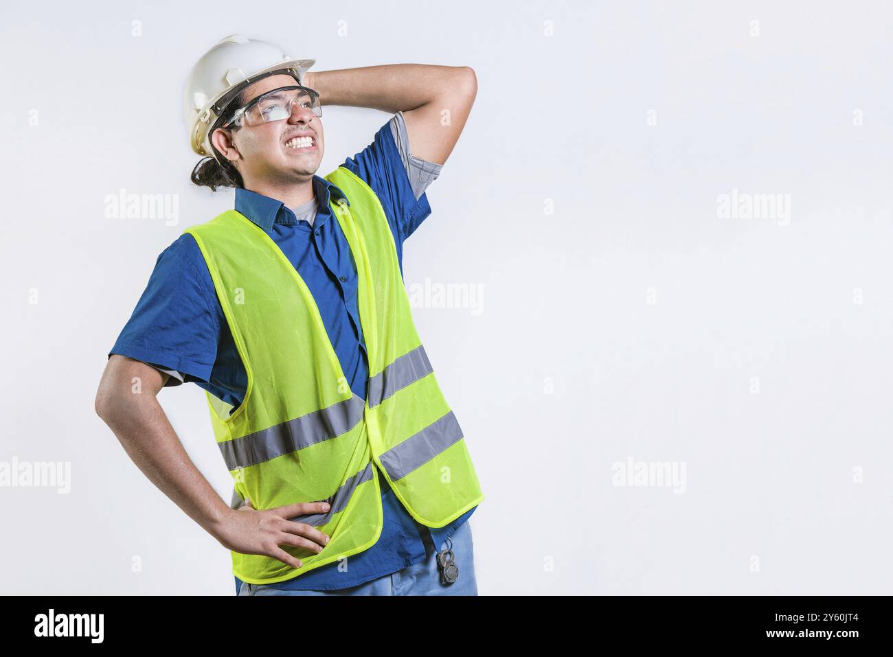 Engineer in problems holding head isolated. Troubled young engineer ...