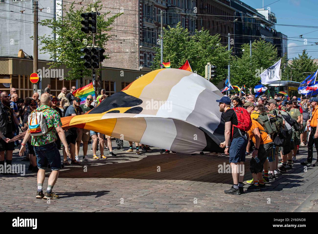 Bear with Us Helsinki. Men waving a giant International Bear ...