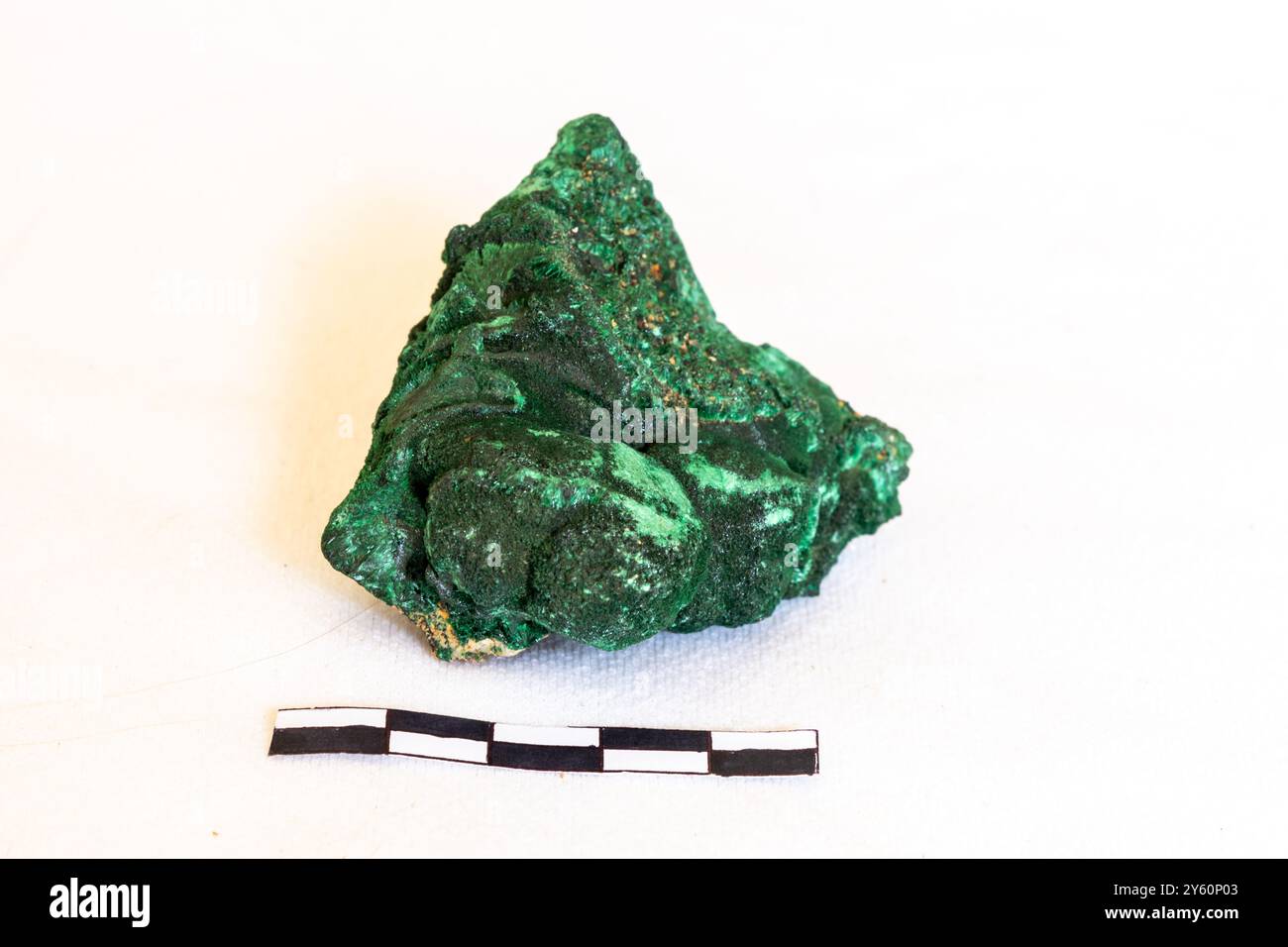 A sample of dark green Malachite on a white background with a 5cm scale ...