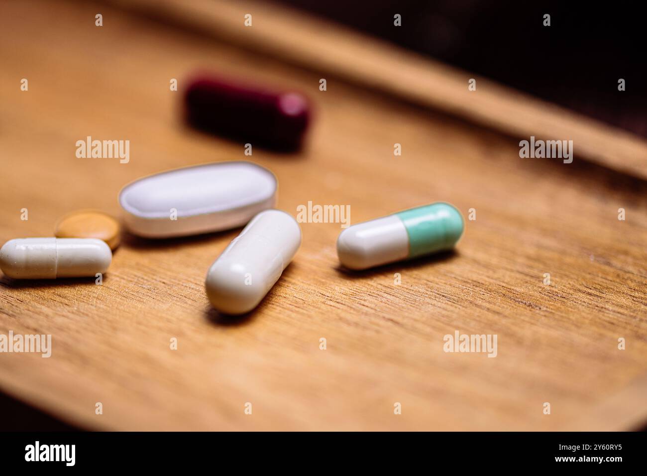 Assorted medication capsules and tablets on wooden surface Stock Photo ...