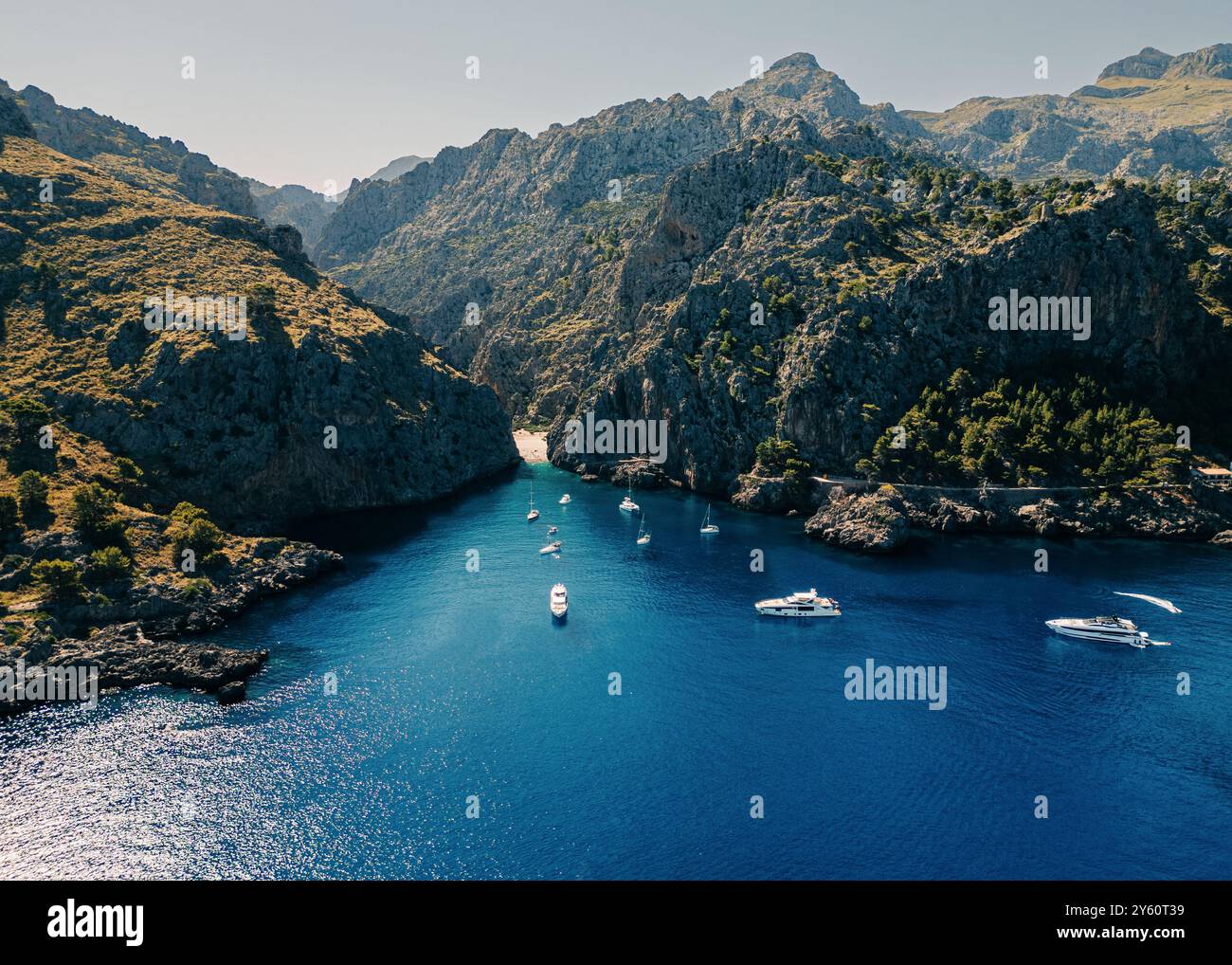 Aerial view of yachts and boats anchored in a secluded bay surrounded ...