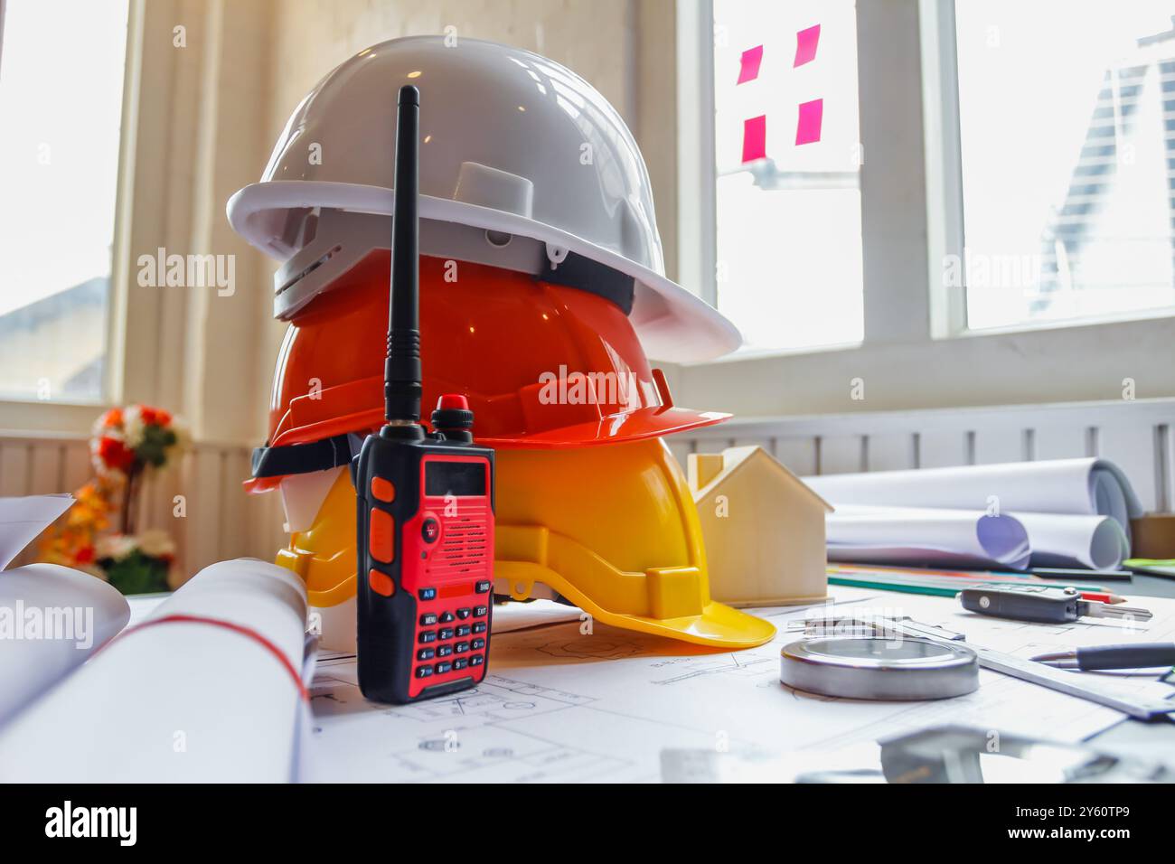 Yellow hard plastic safety helmets sit on work desks in office intended ...