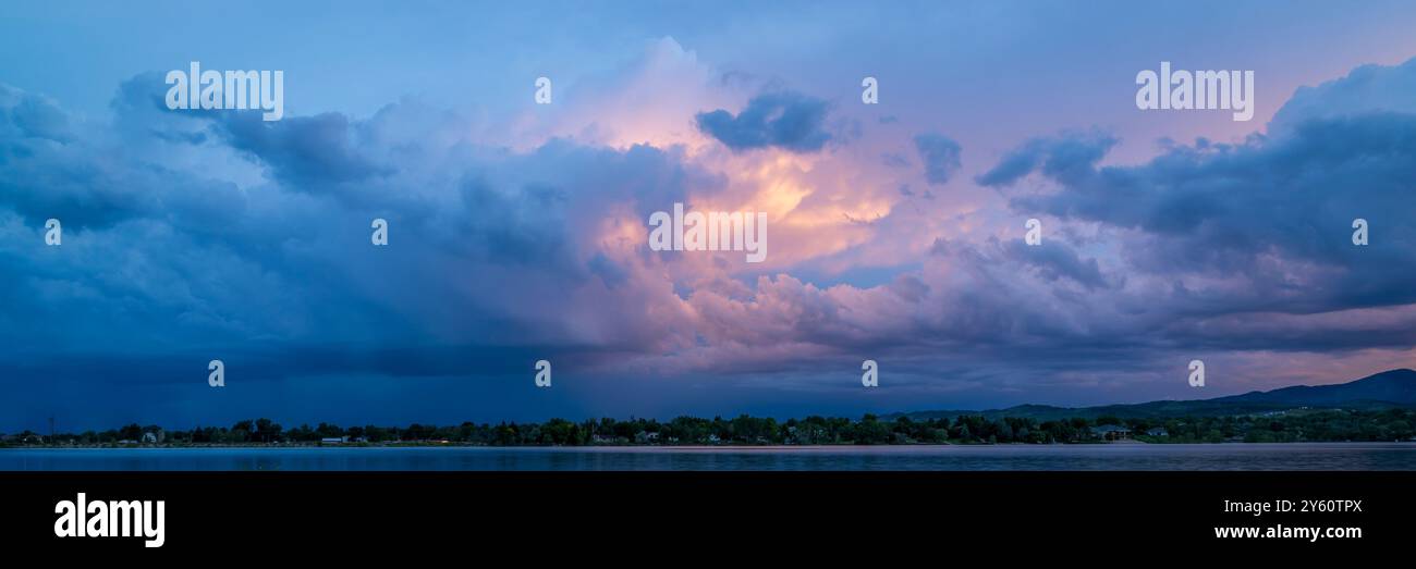 dramatic sunset sky and clouds over Rocky Mountains and lake in northern Colorado Stock Photo ...