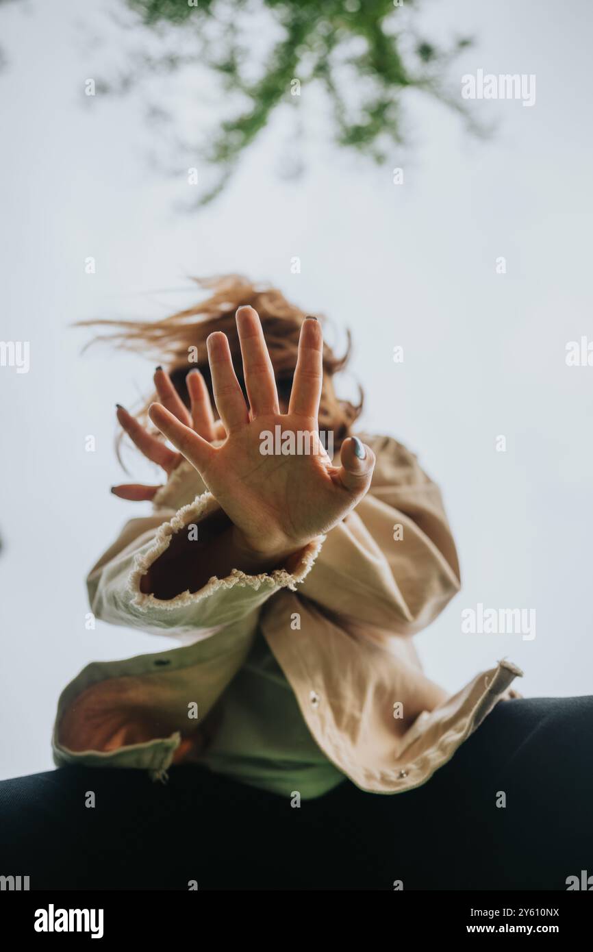 Person reaching out with open hand from below perspective outdoors ...