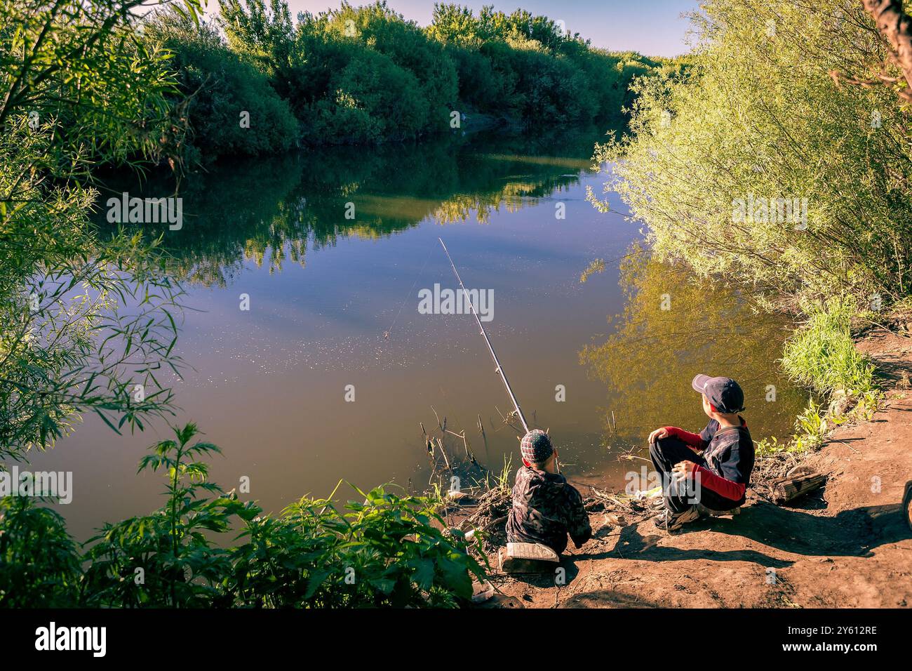 Fishing in deep blue water lake Stock Photo - Alamy