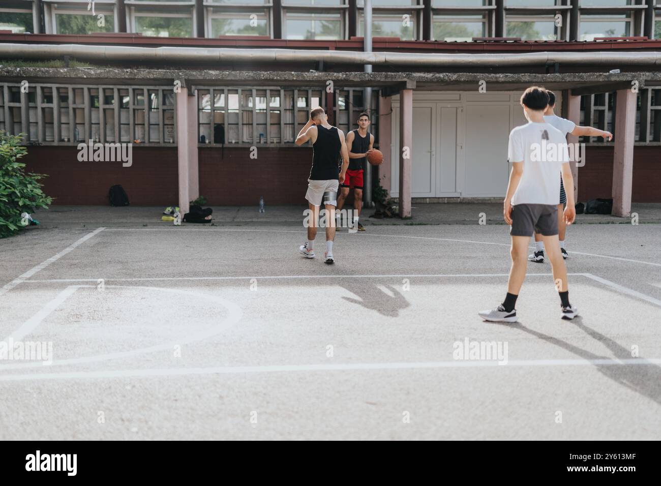 Group of friends enjoying a game of basketball on an old neighborhood ...