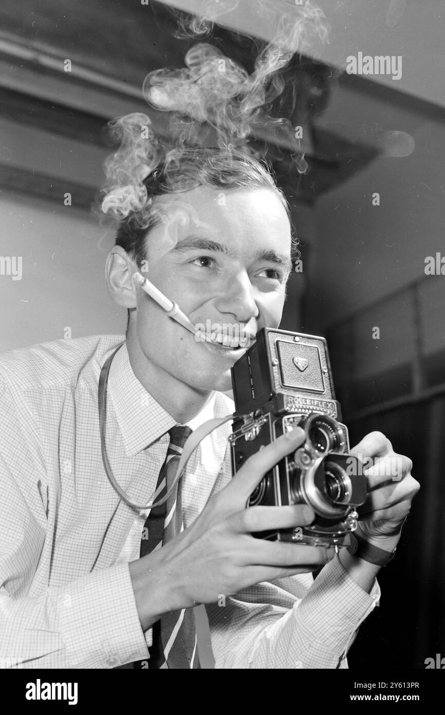 With his head wreathed in cigarette smoke, society photographer Tom ...