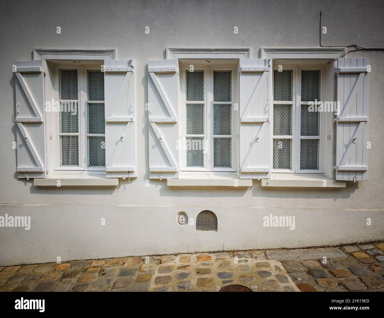 Traditional windows shutters on white building facade in Montmartre ...