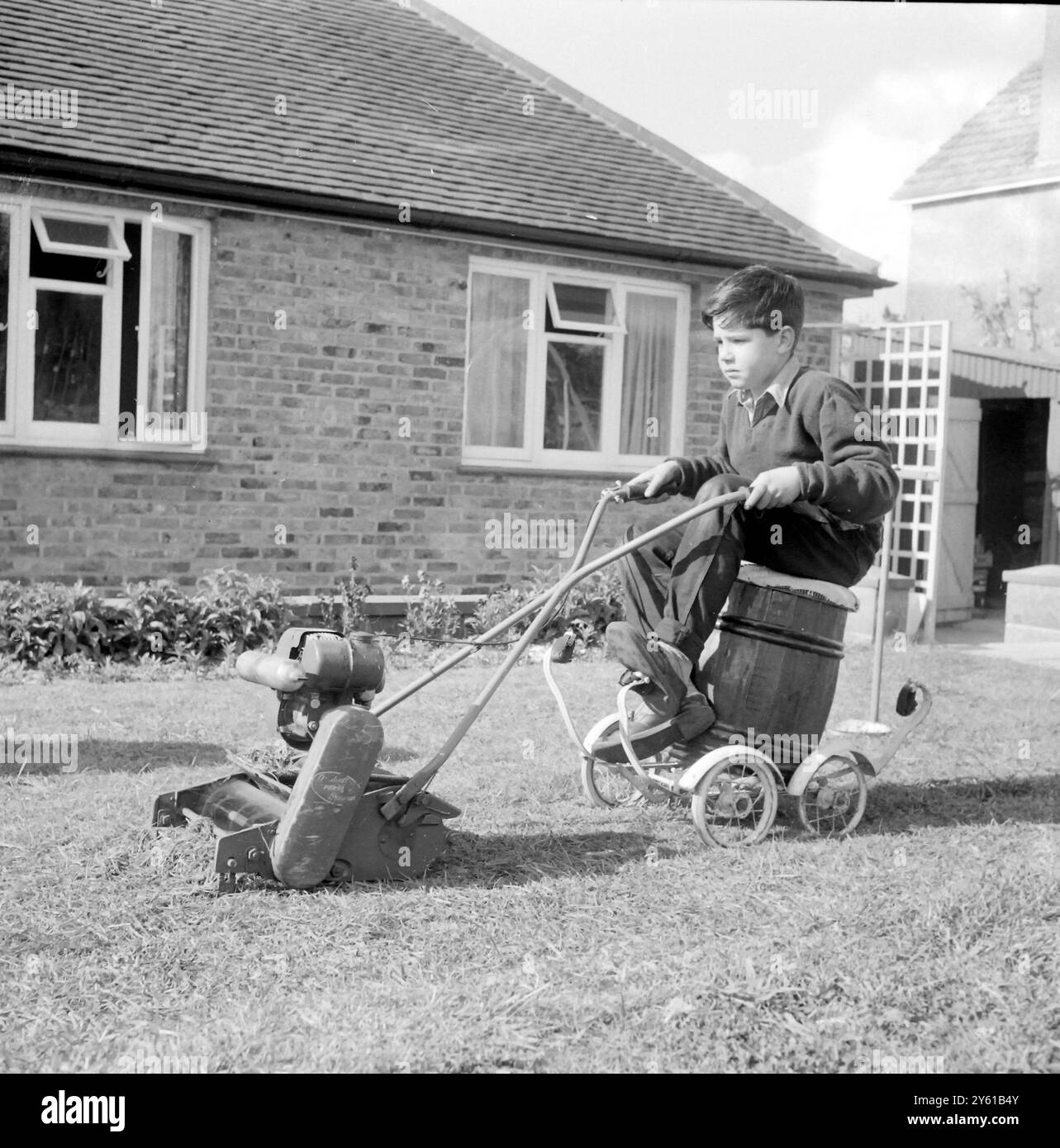 LAWN MOWERS BREGAN RICHARD SITS ON CHASSIS OF PRAM AND MOWS LAWN 3 JUNE ...