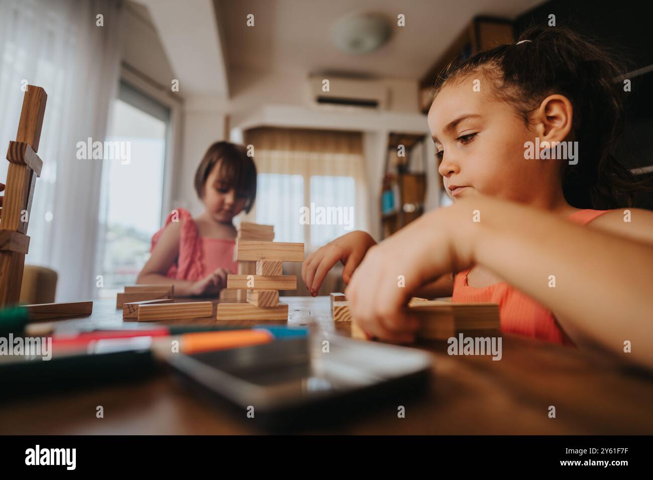 Children playing with building blocks in a bright living room Stock ...