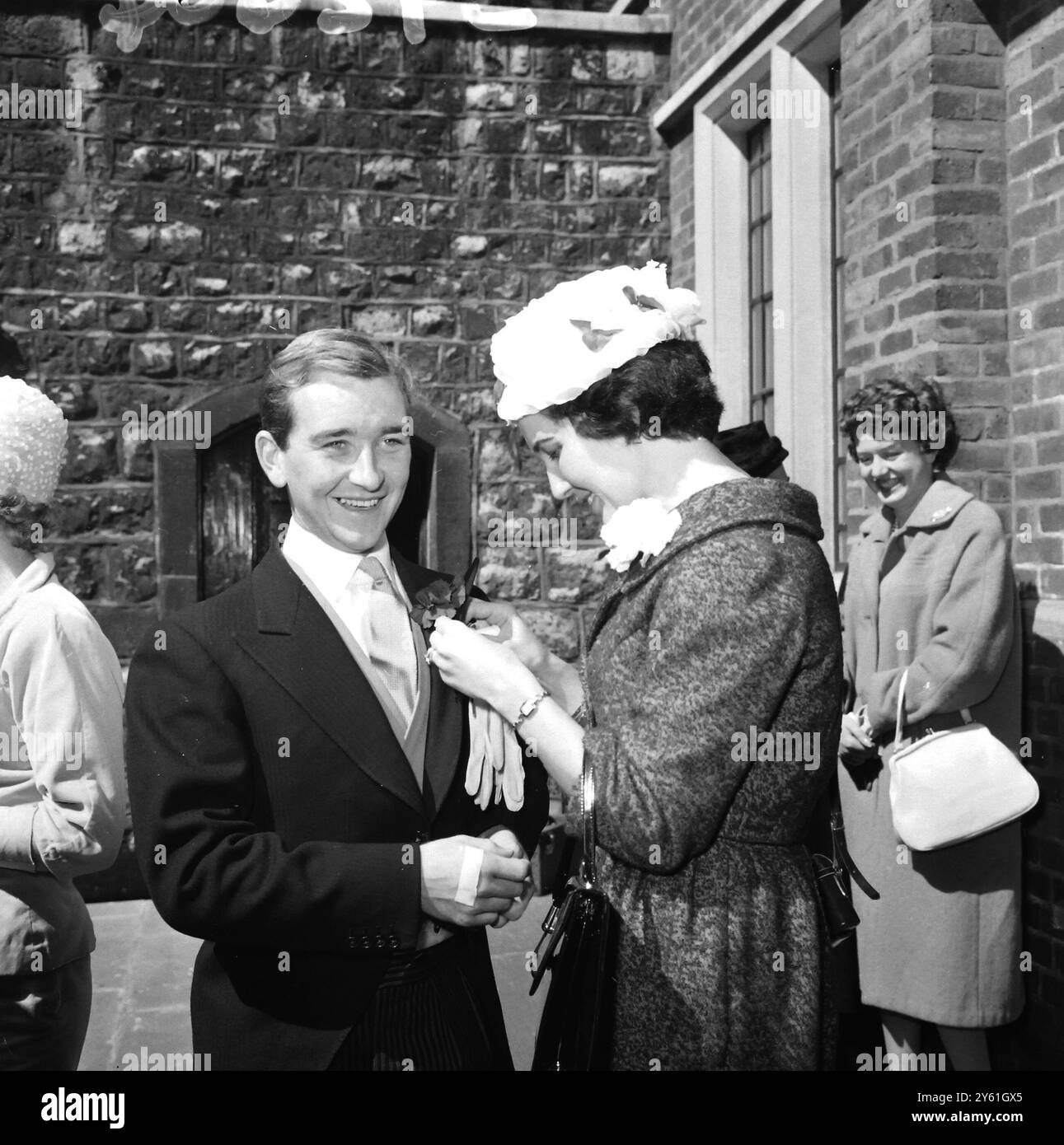 ROY SWETMAN HAS HIS BUTTON FIXED BY HIS WIFE ANN AT THE WEDDING OF ...