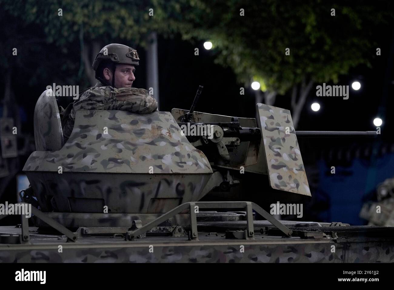 A Lebanese army soldier sits behind his weapon on the top of an armored ...