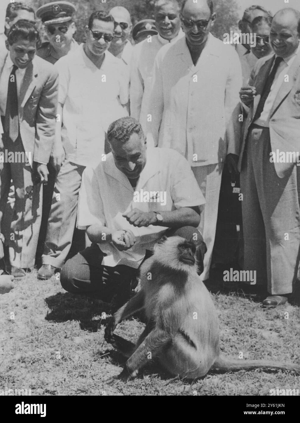 PRESIDENT NASSER OF EGYPT FEEDS A MONKEY NEAR THE TOMB OF THE GREAT ...
