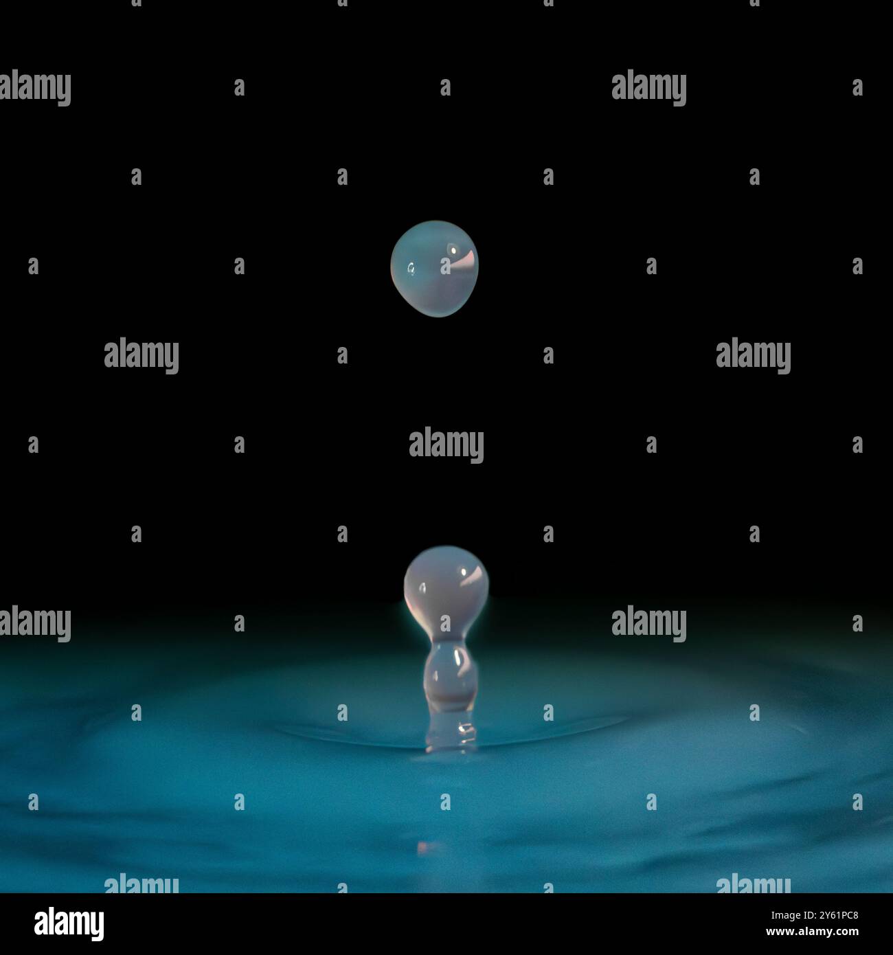 minimalist photography, of a drop of water, a splash, a wave spreading ...