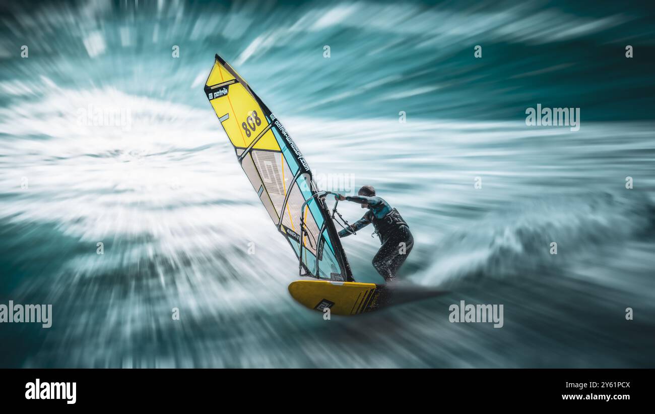 windsurfer takes a sharp turn on the Mediterranean sea, artistic vision ...