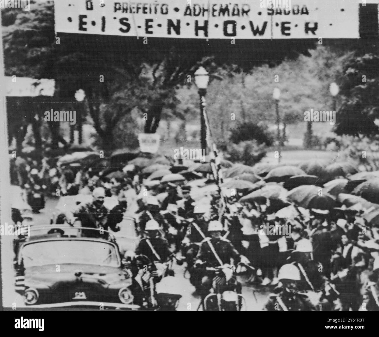 PRESIDENT DWIGHT EISENHOWER WAVES TO CROWDS AS HE RIDES IN THE ...