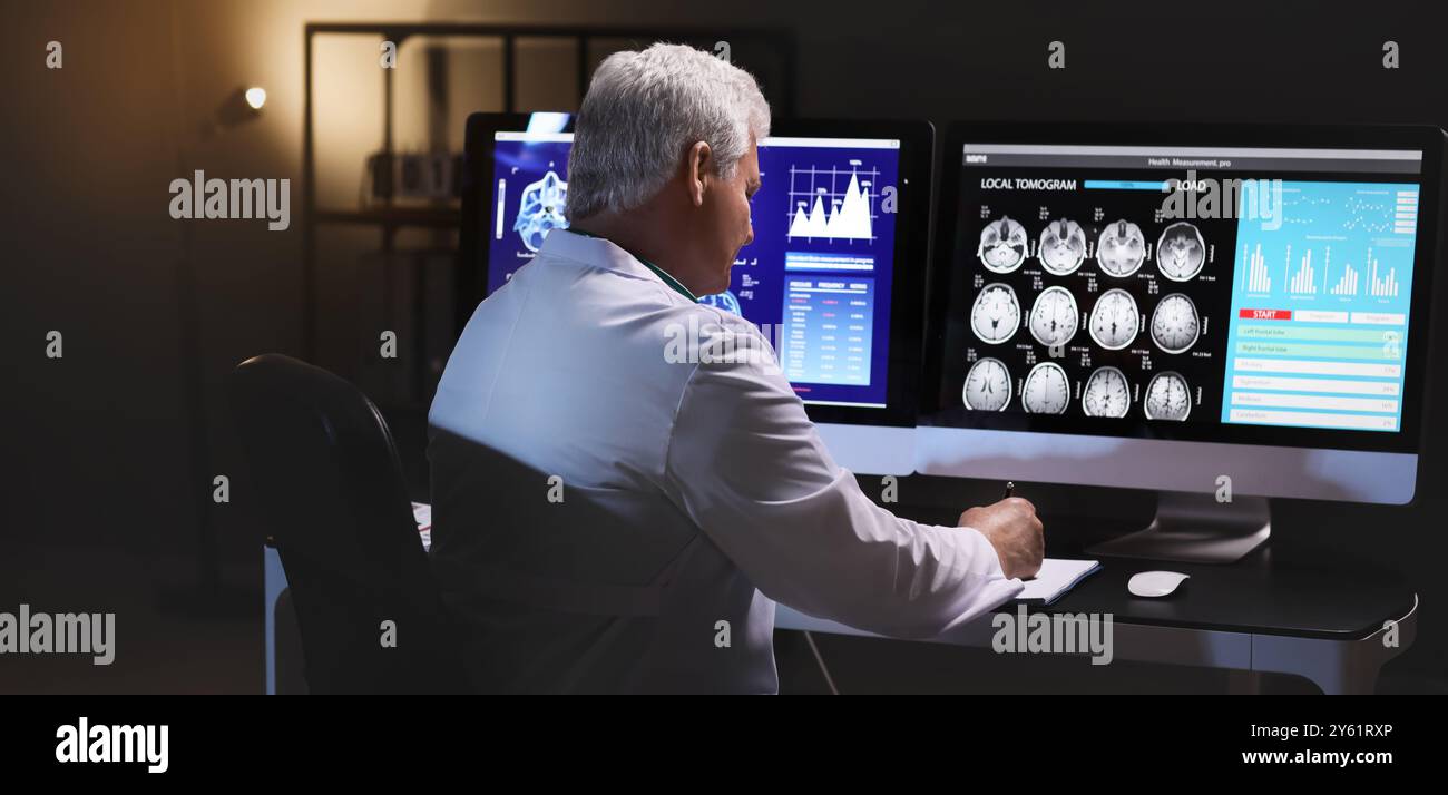 Senior neurologist with MRI scans of human head in clinic Stock Photo ...