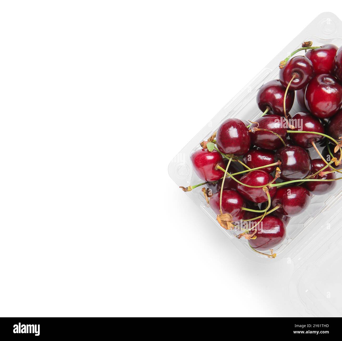 Plastic container with fresh cherry on white background Stock Photo - Alamy