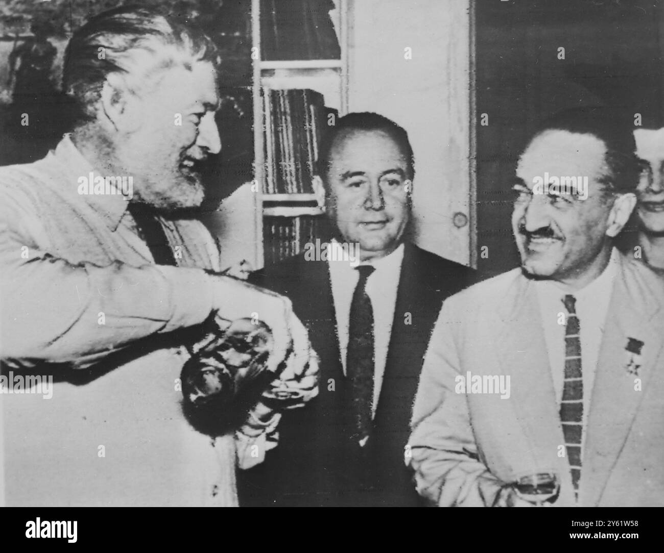 AUTHOR ERNEST HEMINGWAY ( LEFT ) POURS OUT VODKA TO DRINK A TOAST TO ...
