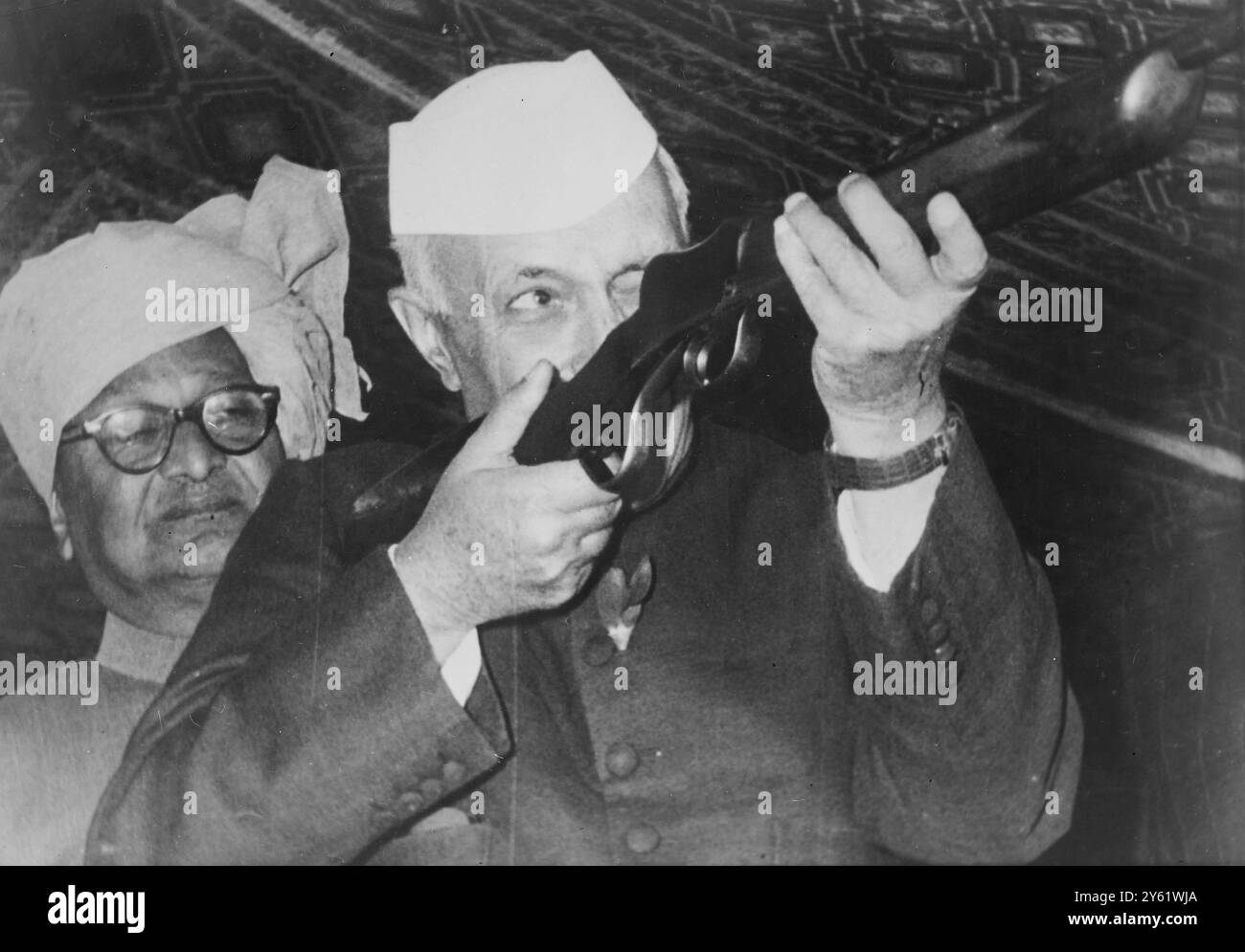 INDIAN PRIME MINISTER NEHRU SHOOTING A RIFLE FOR THE OPENING SHOT AT ...