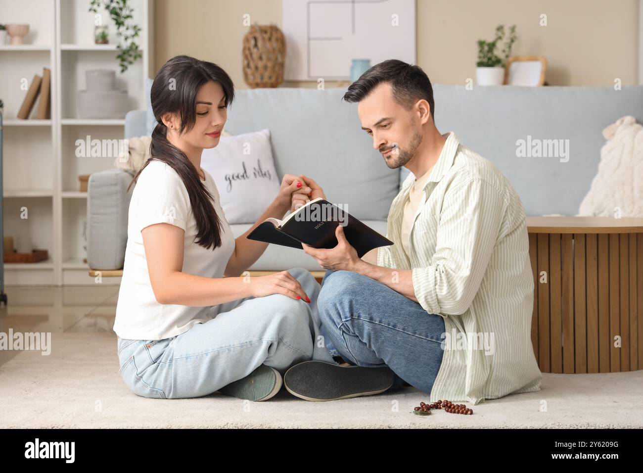 Religious couple reading Holy Bible at home Stock Photo - Alamy