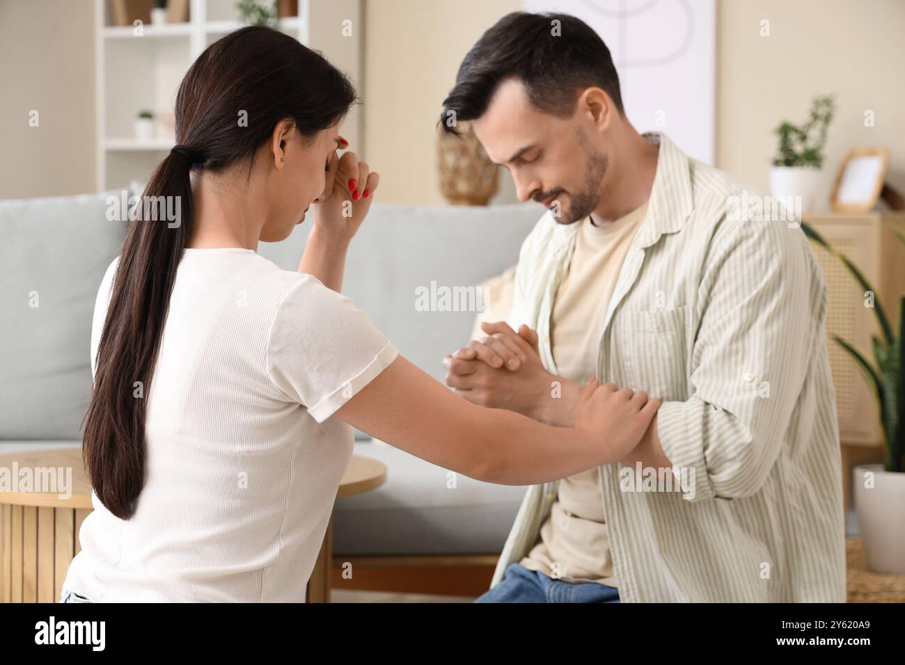 Religious couple praying at home Stock Photo - Alamy