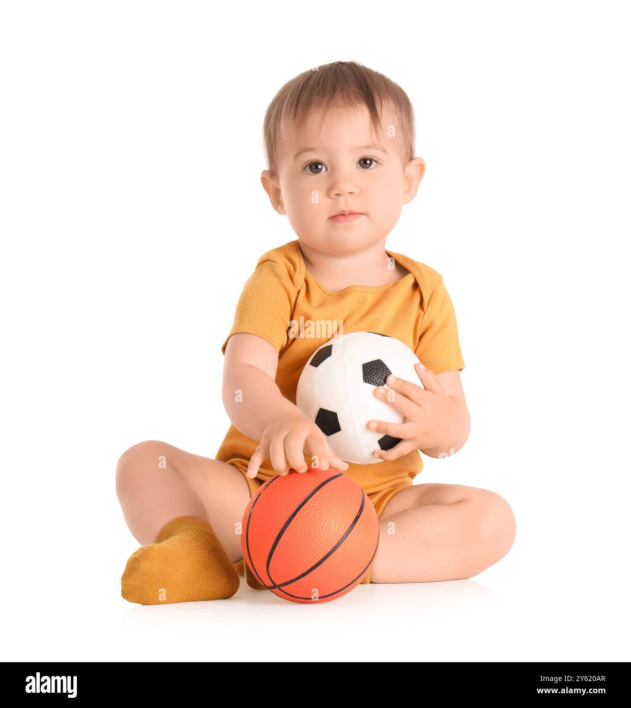 Cute baby with balls on white background Stock Photo - Alamy