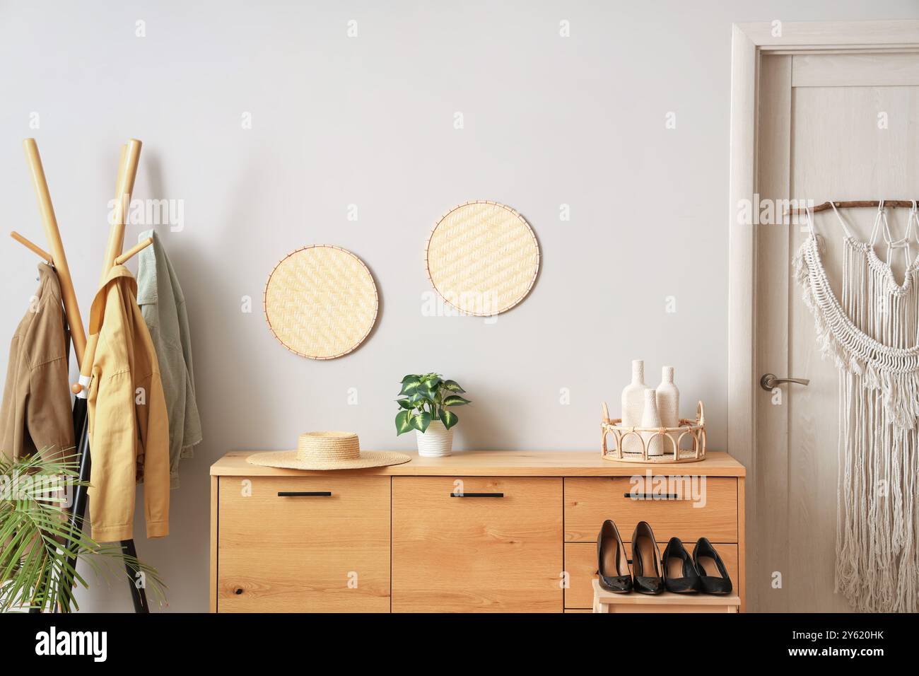 Interior of hall with commode, coat rack and door Stock Photo - Alamy