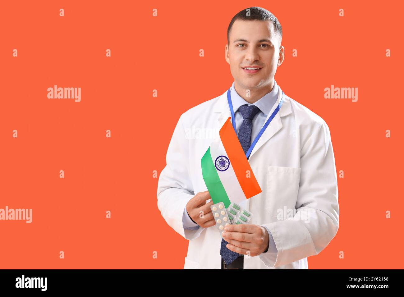 Male physician with flag of India on orange background. National Doctor ...
