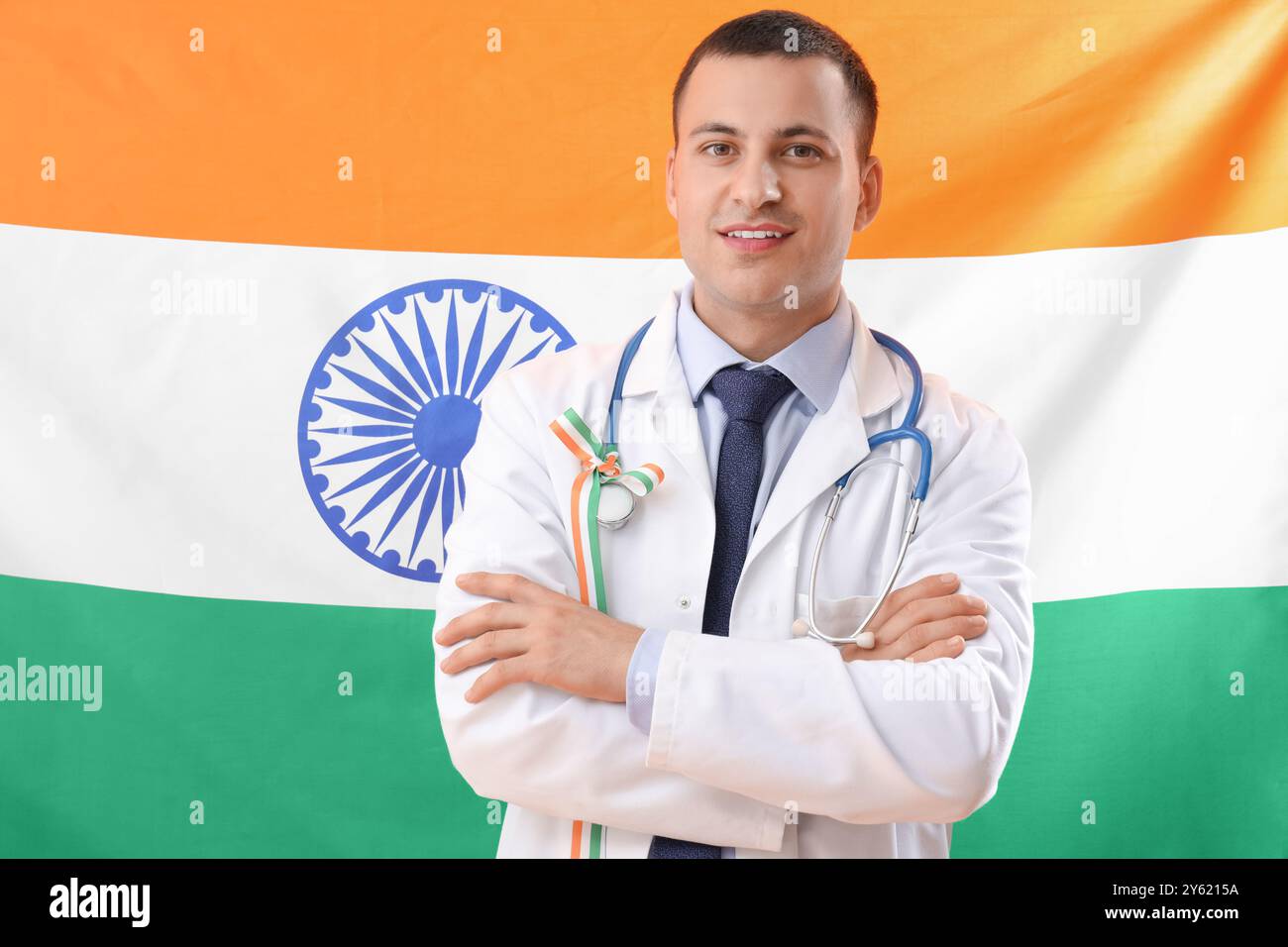 Male physician with ribbon against flag of India. National Doctor's Day ...