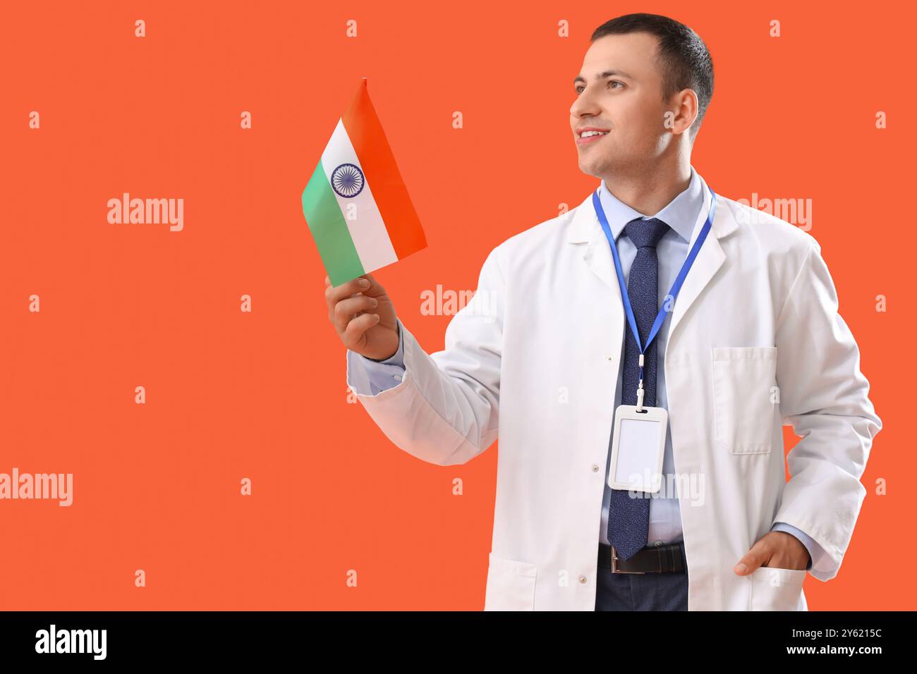 Male physician with flag of India on orange background. National Doctor ...