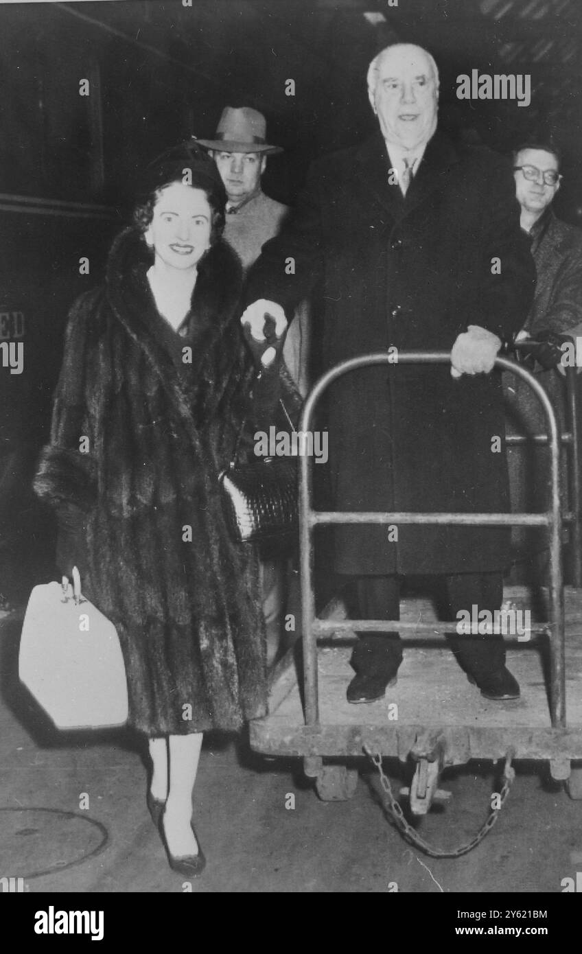 CONDUCTOR SIR THOMAS BEECHAM RIDES ON A RAILWAY STATION BAGGAGE TROLLEY ...