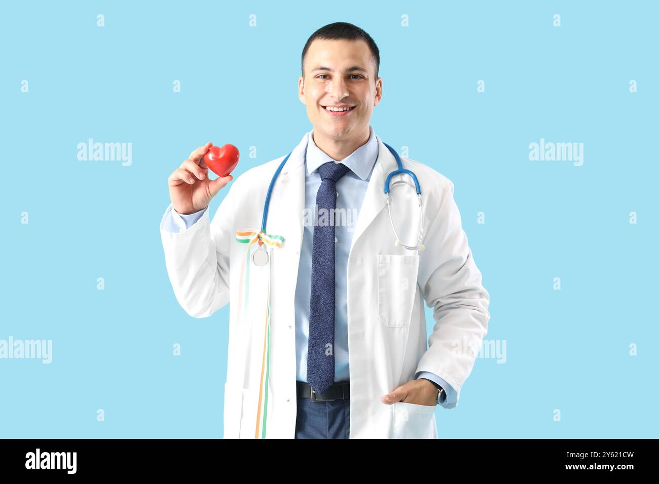 Male doctor with heart and ribbon in colors of Indian flag on blue ...
