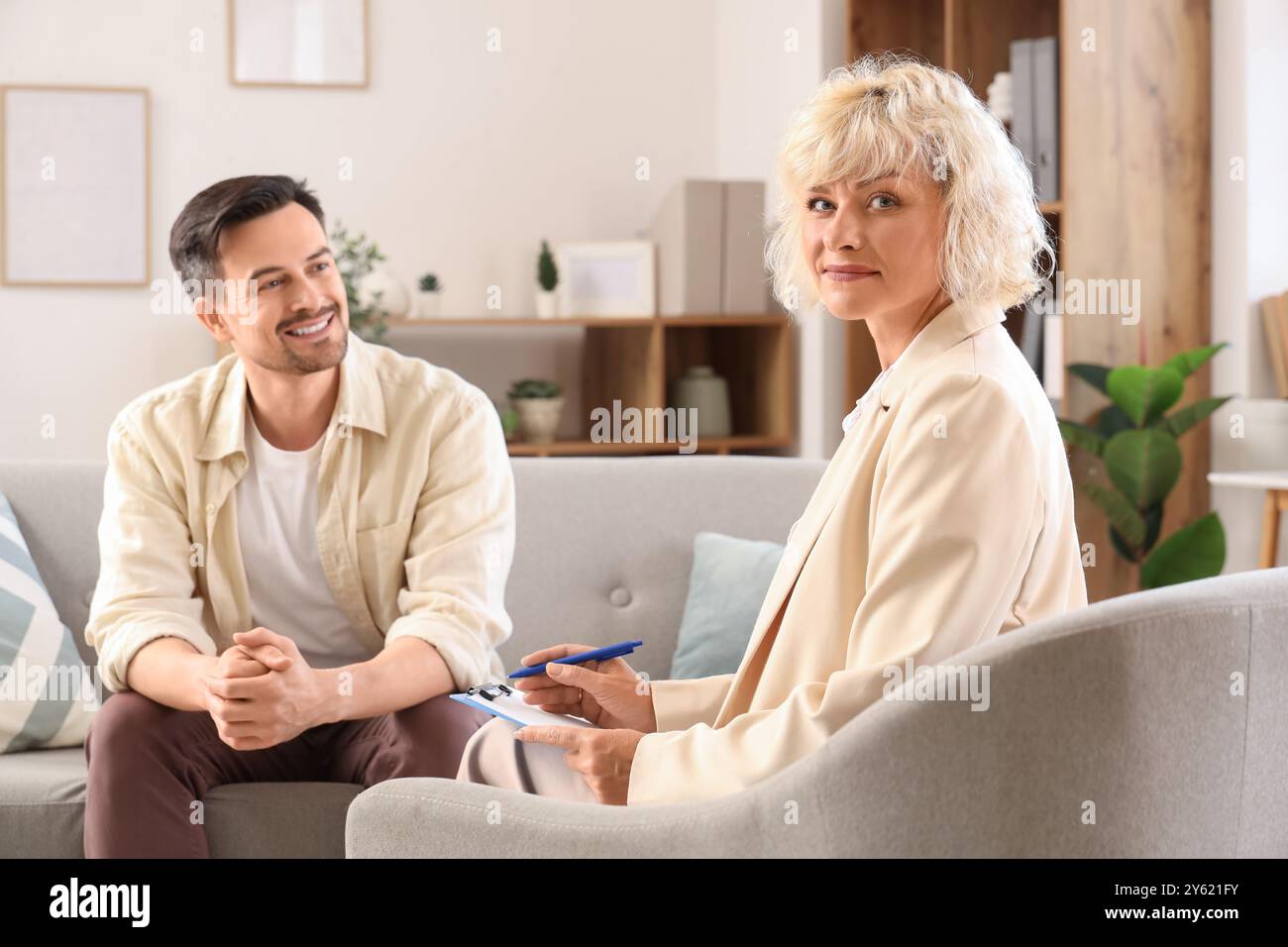 Female psychologist working with young man in office Stock Photo - Alamy