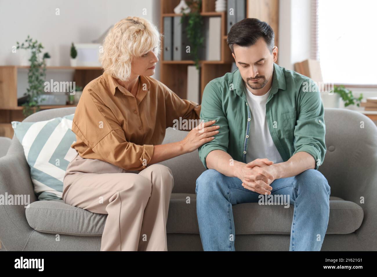 Female psychologist working with sad man in office Stock Photo - Alamy