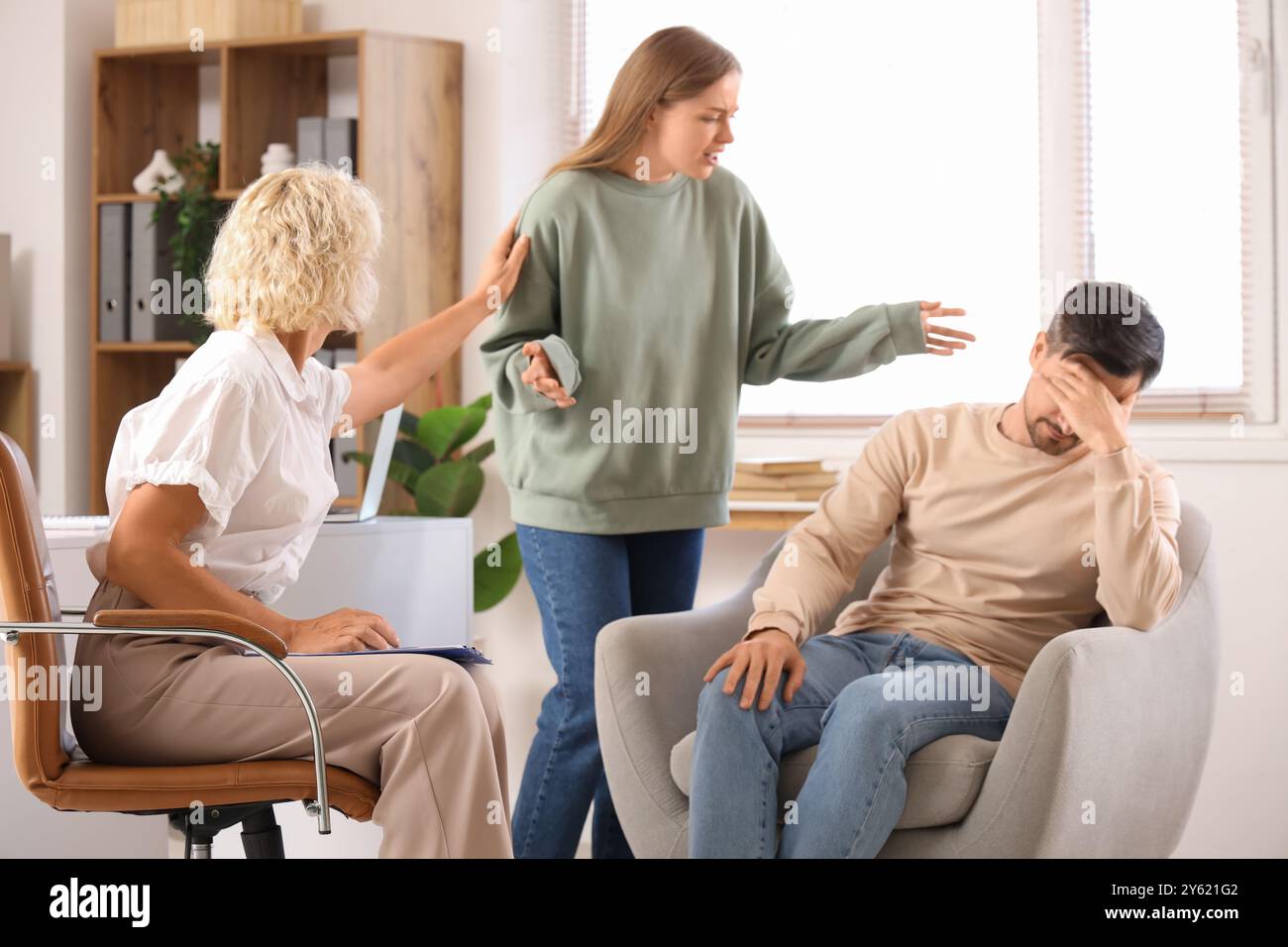 Female psychologist working with angry couple in office Stock Photo - Alamy