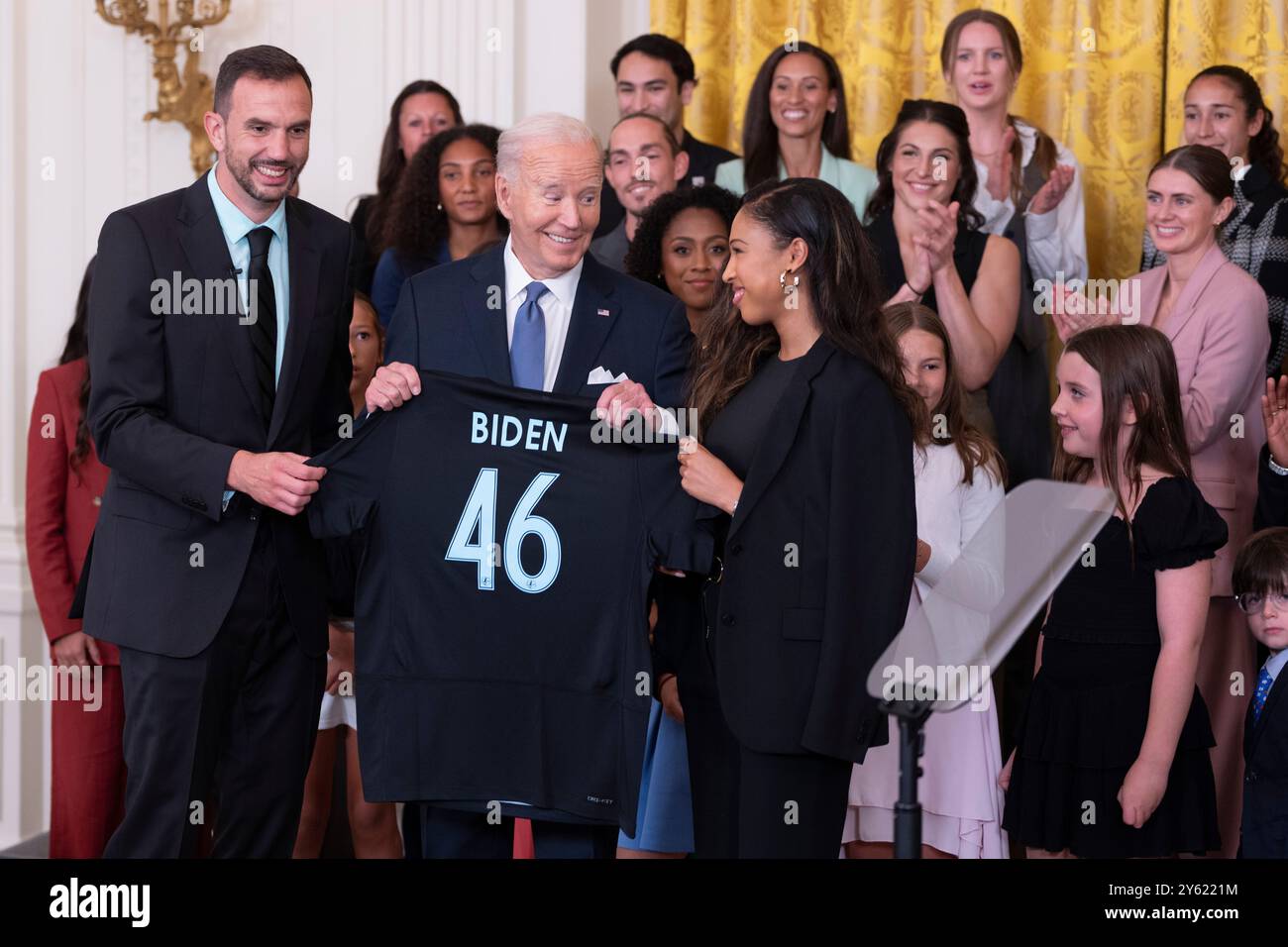 United States President Joe Biden receives a team jersey from Coach ...