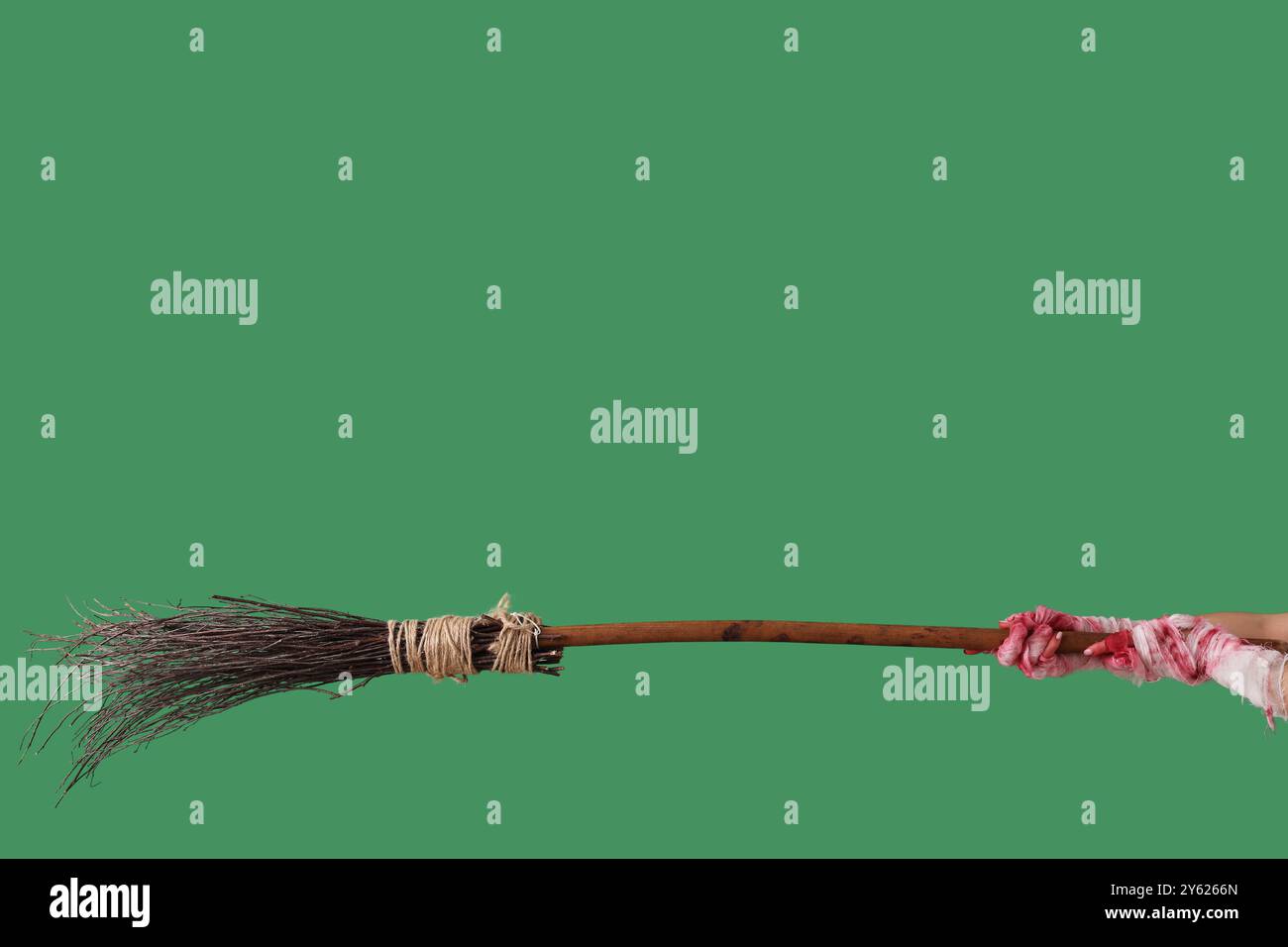 Mummy hands with broom on green background. Halloween celebration Stock ...