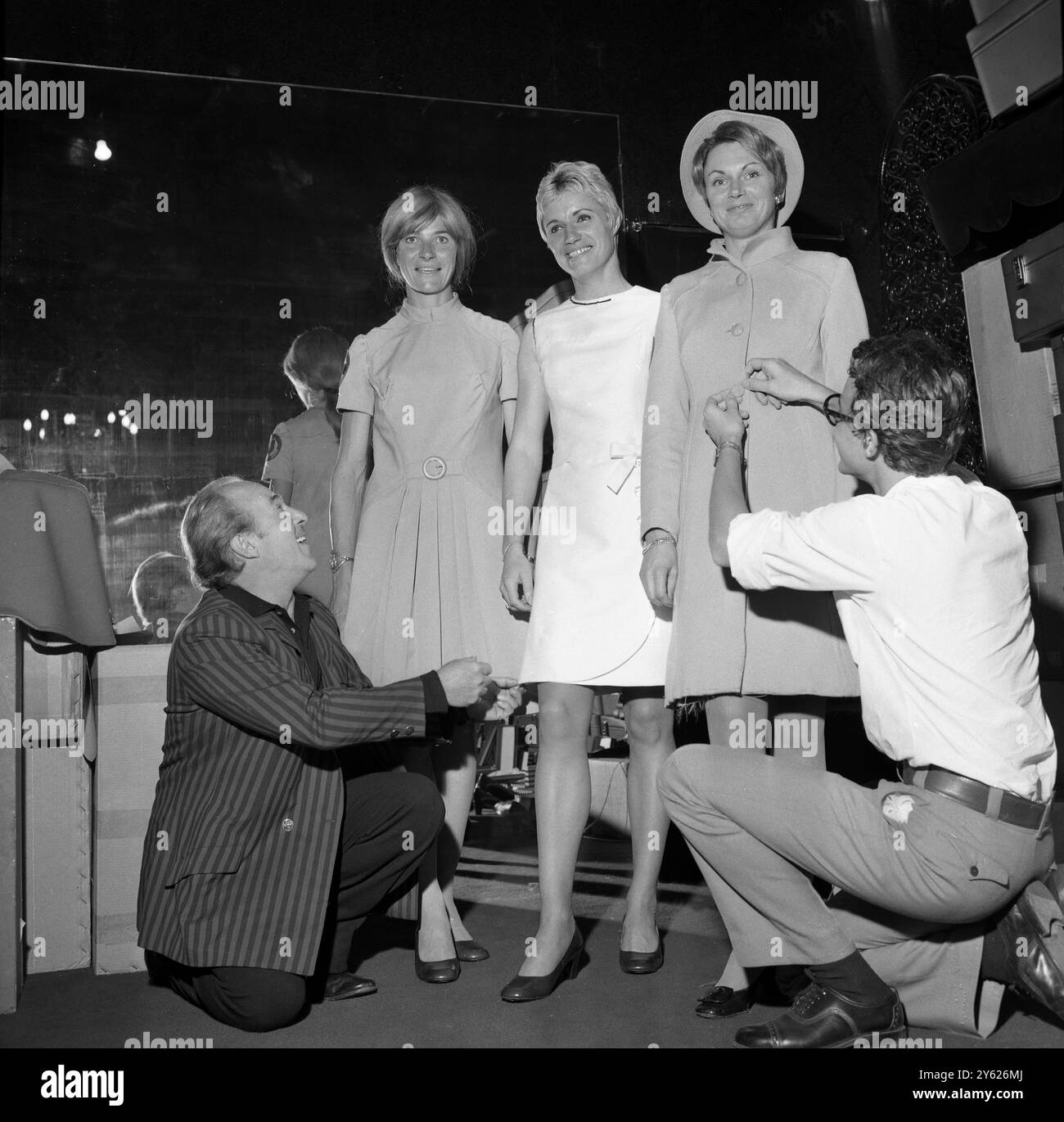 Paris fashion designer Jacques Esterel ( left ) gives the final touches ...