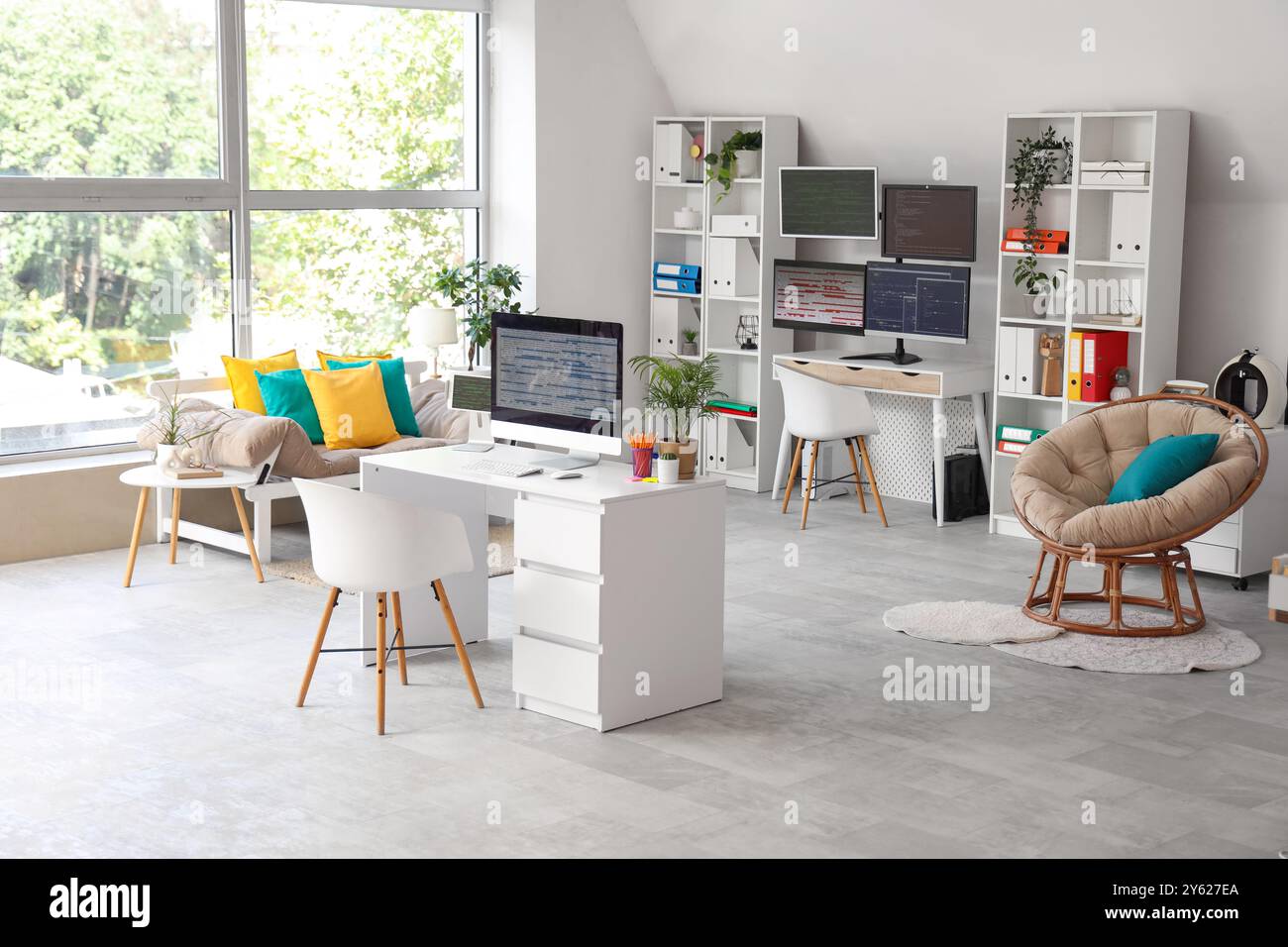 Interior of light programmer's office with desks, shelf units and sofa ...