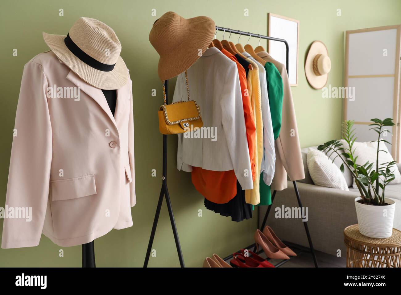 Interior of dressing room with mannequin, clothes rack and sofa Stock ...