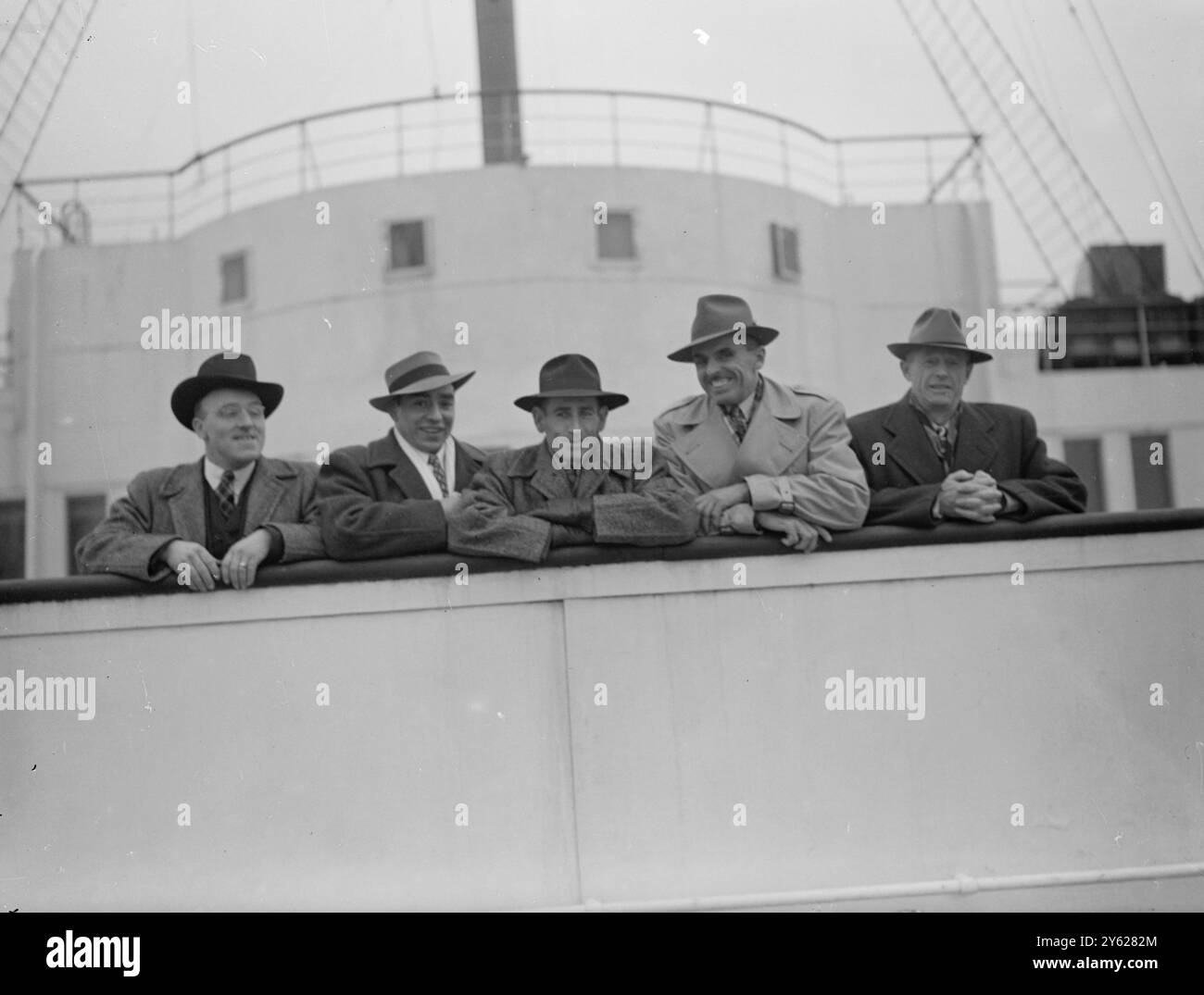 Passengers aboard the "Queen Mary" docking at Southampton from New York ...