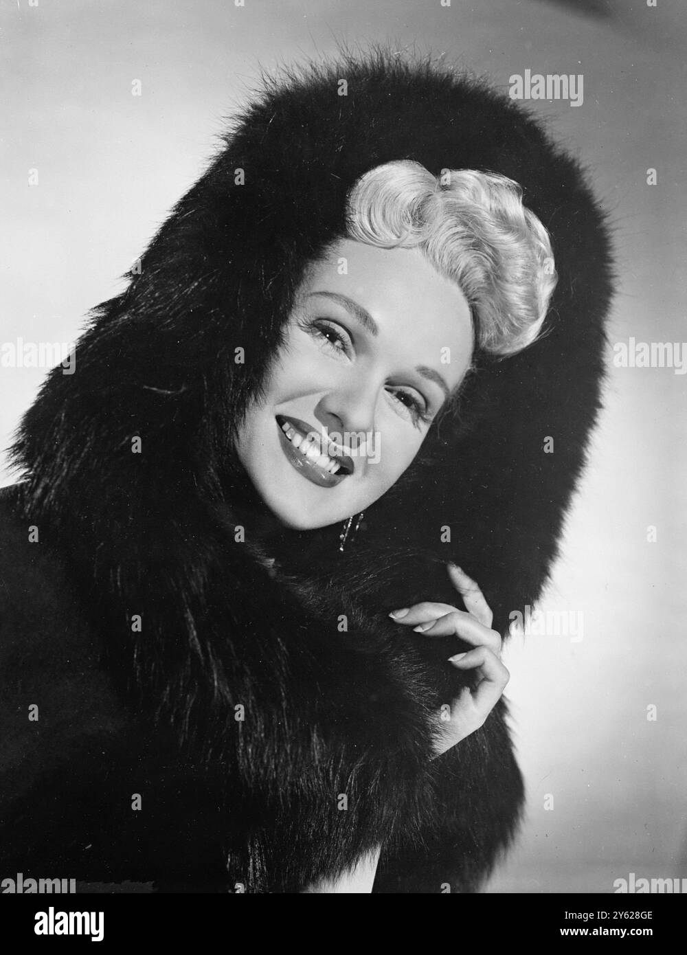 Champagne - blonde Adele Jergens smiling Columbia Pictures' star is ...