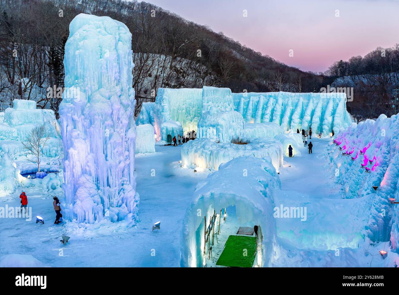 Visitors exploring huge frozen ice sculptures on the shore of Lake ...