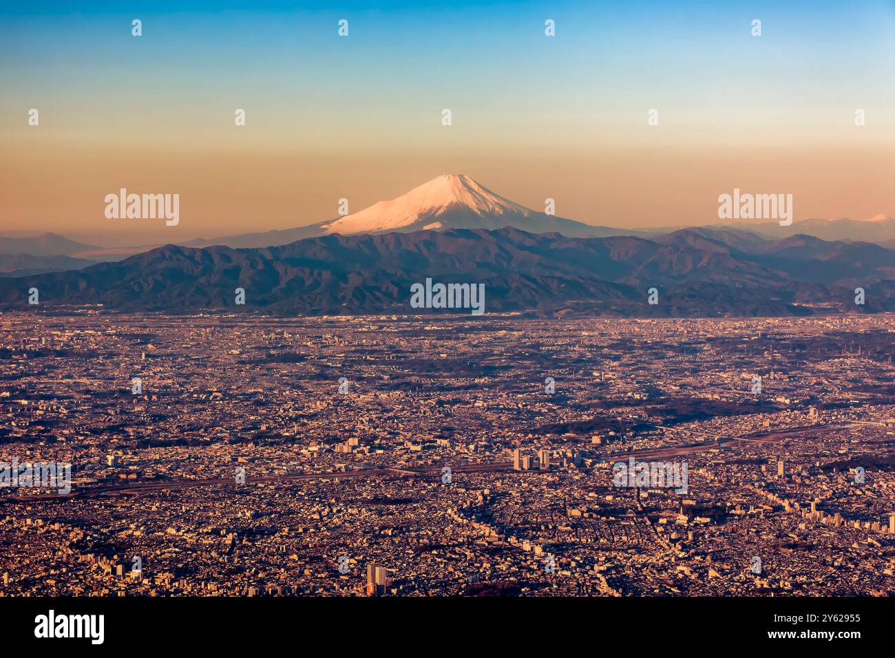 Aerial view of a snow-capped Mount Fuji and Tokyo at sunrise Stock ...