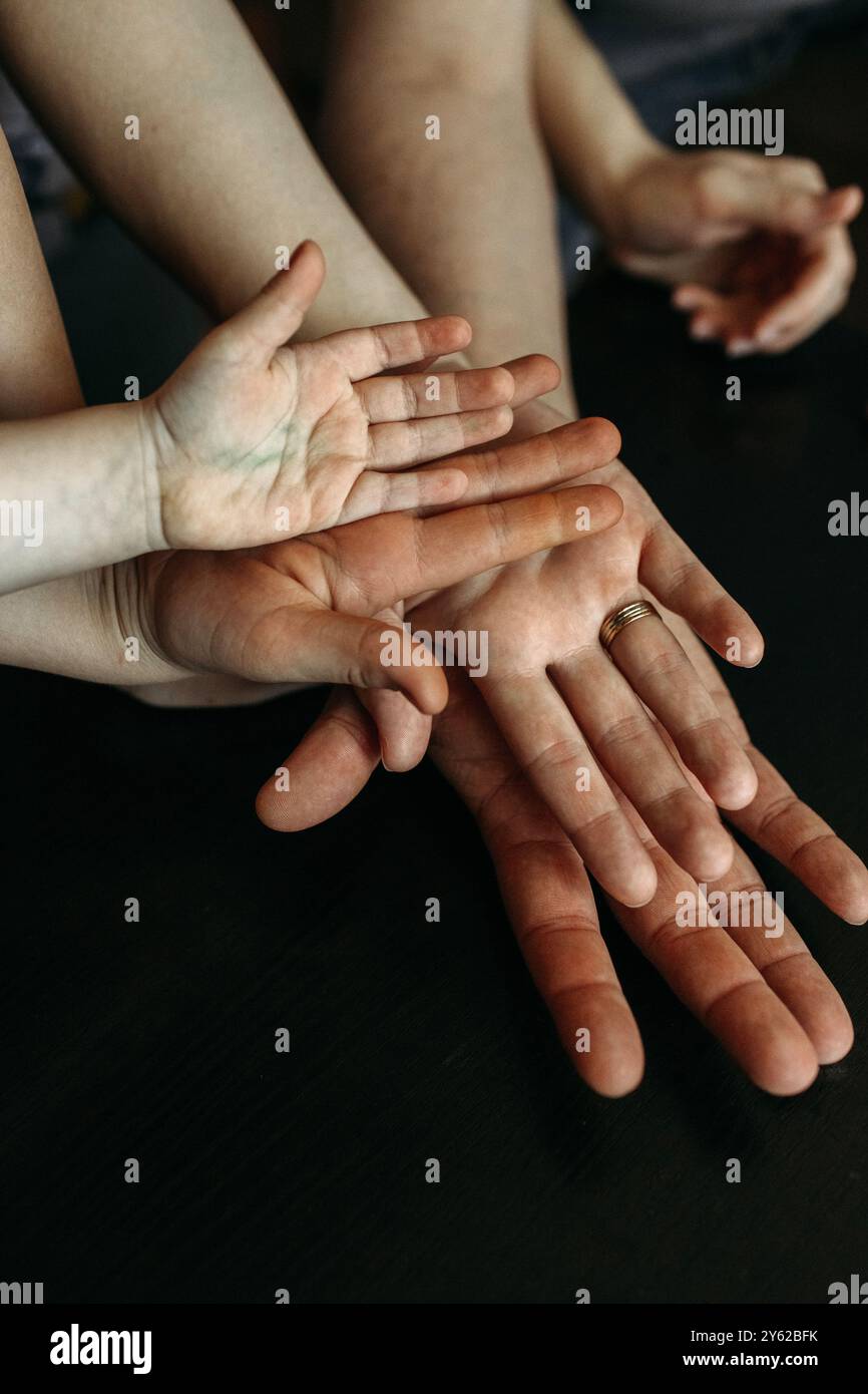Different generations intertwine their hands, showcasing the beauty of ...